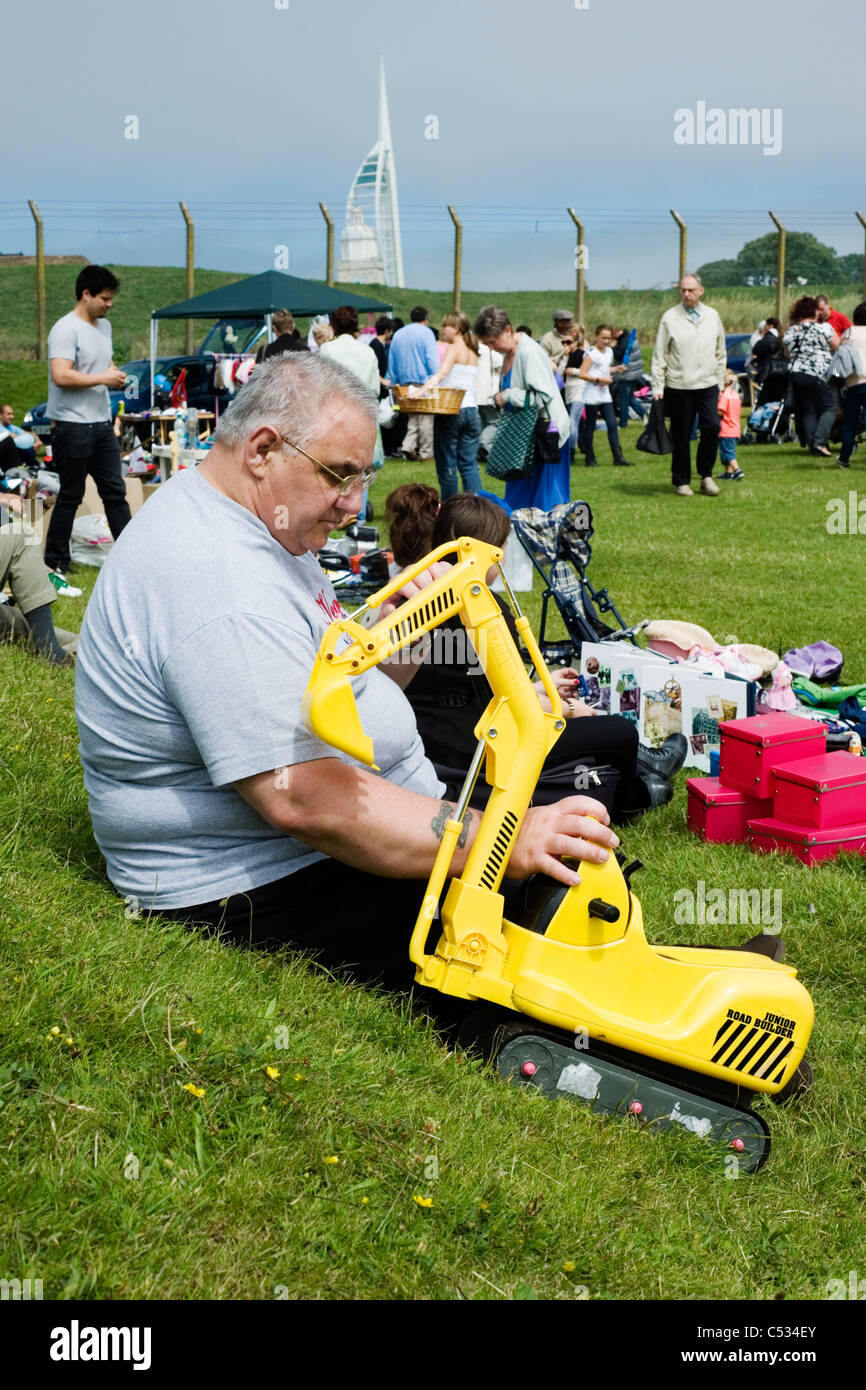 elderly man with purchase of toy at car boot sale southsea seafront ...