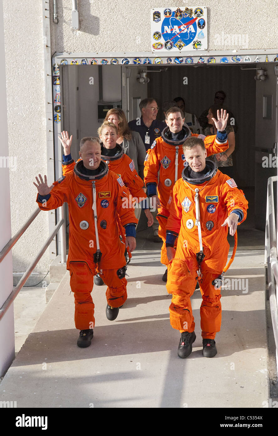 During a simulated launch countdown, the STS-135 crew walks out of the ...