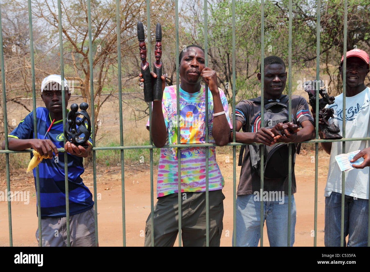 African men sell souvenirs at the border between Zambia and Zimbabwe ...