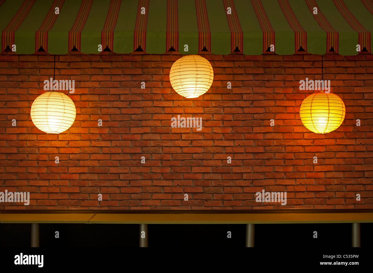 Brick wall with three illuminated lamps. Lighting Stock Photo - Alamy
