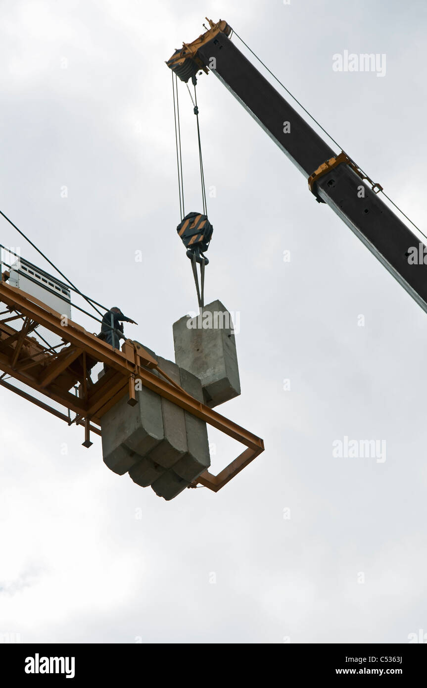 Two cranes assembly on sky background Stock Photo - Alamy
