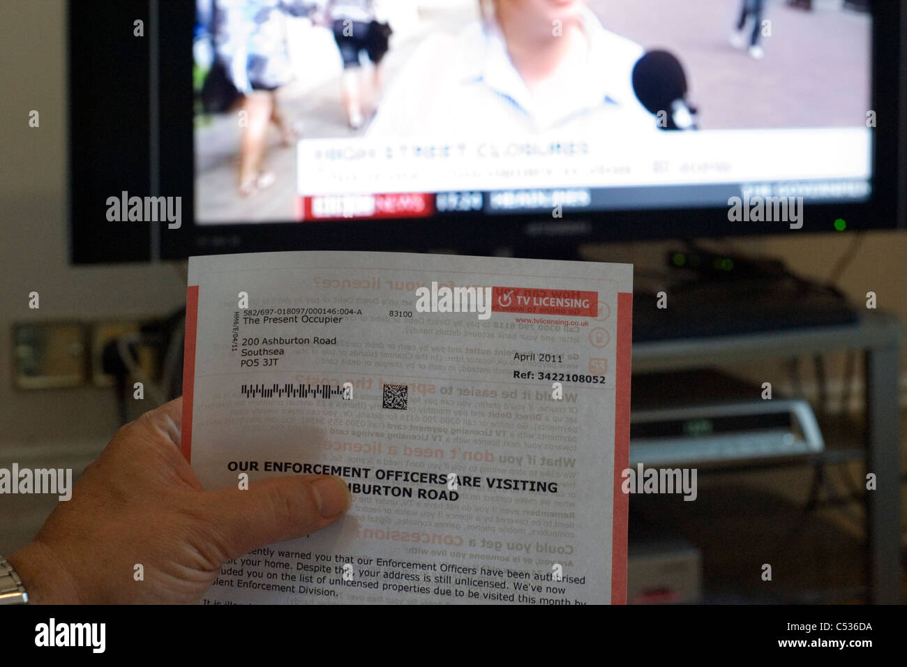 man holding letter warning of visit by licensing authorities television ...