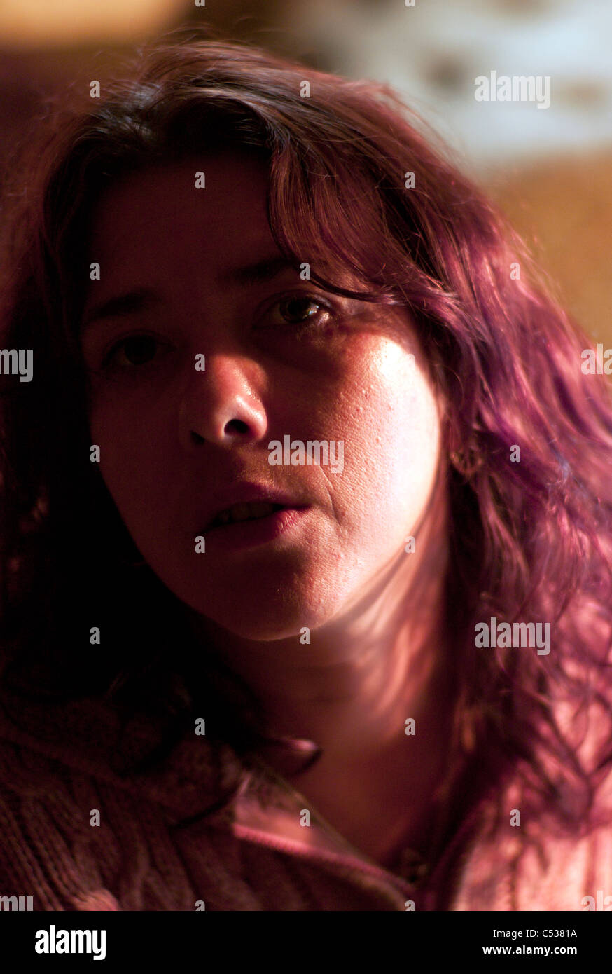 Pretty woman with red hair with her face in light and shadow Stock ...