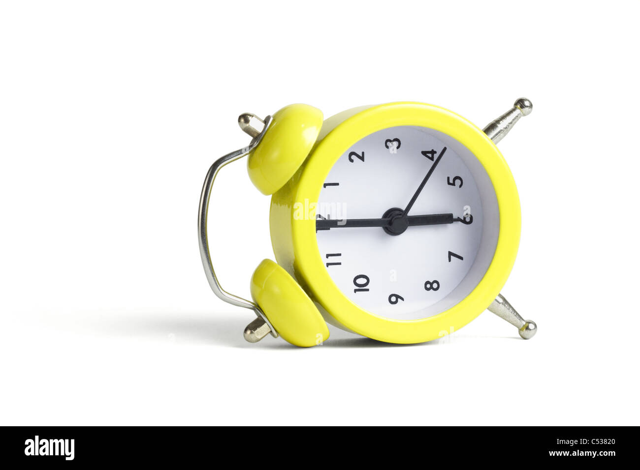 Alarm clock on yellow Cut Out Stock Images & Pictures - Alamy