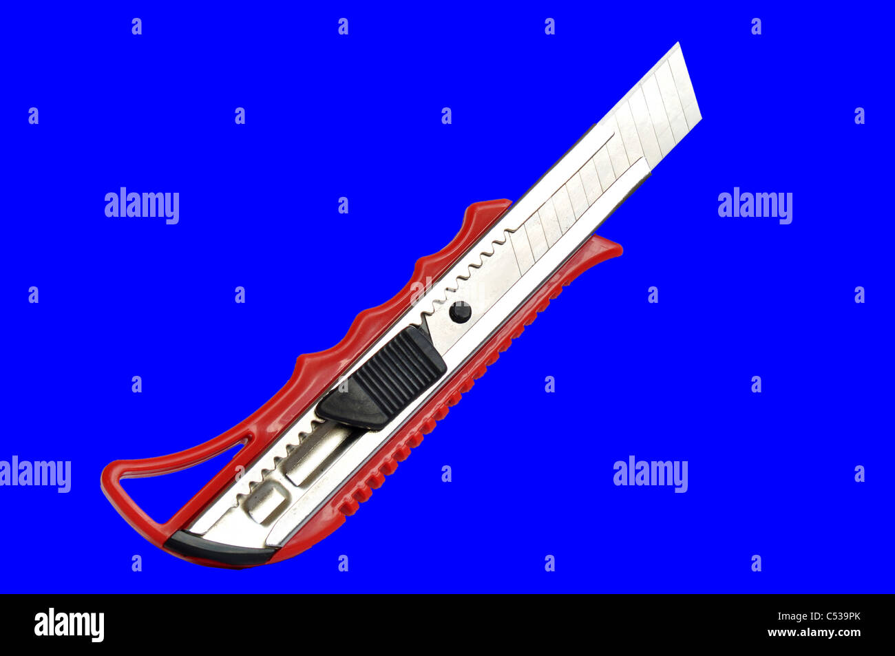 A sharp paper knife isolated on a blue background Stock Photo - Alamy