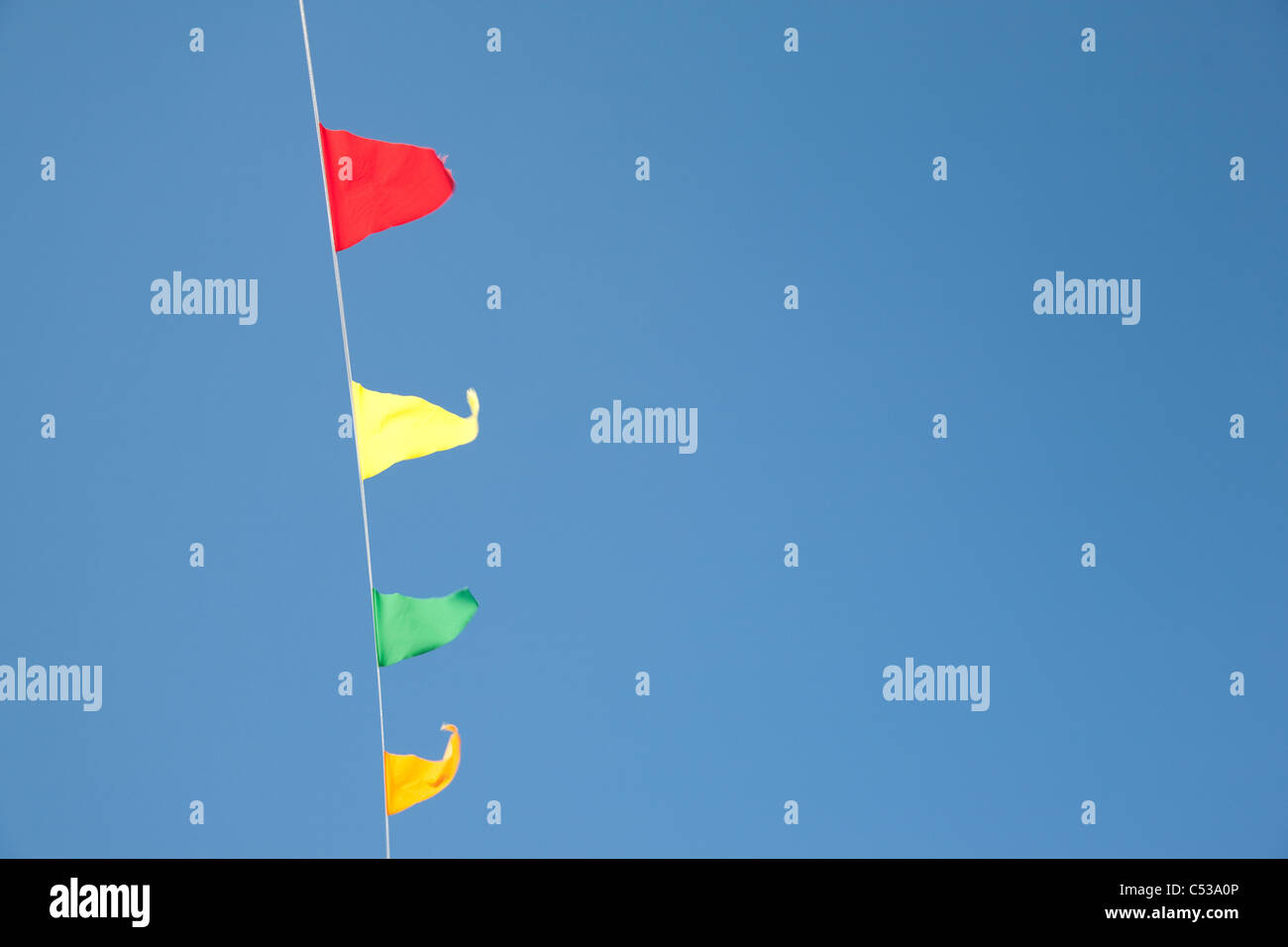 Colorful Flags Blowing in the Wind Stock Photo - Alamy