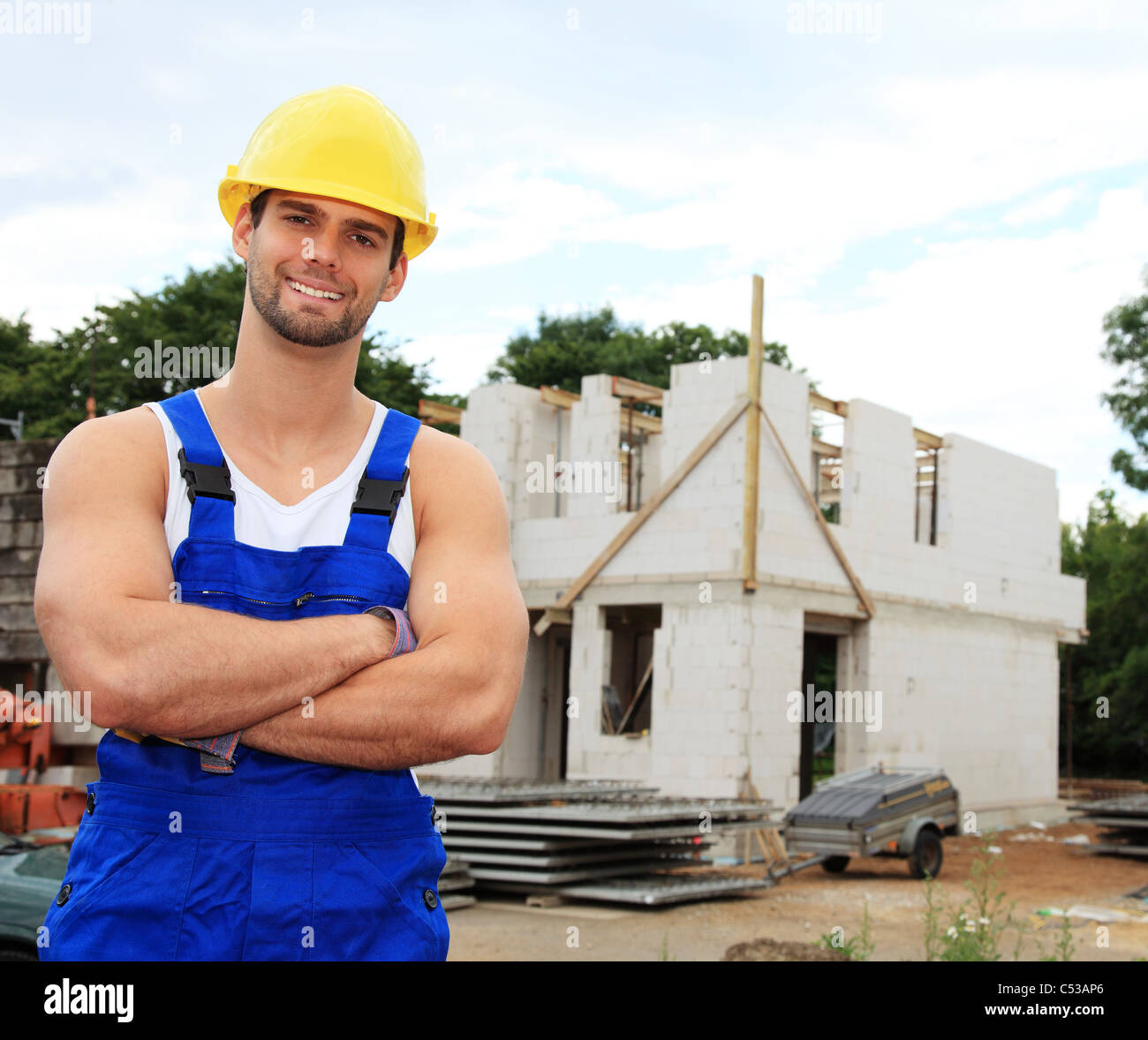 Manual worker on construction site Stock Photo - Alamy