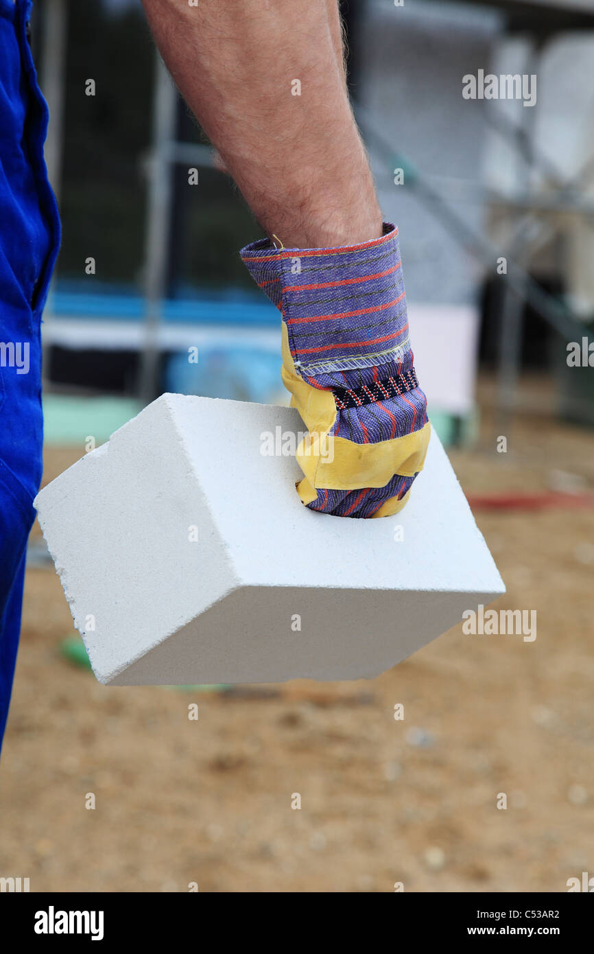 Worker carrying brick hi-res stock photography and images - Alamy