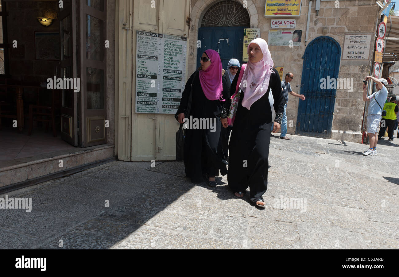 Two Muslim woman pass by a restaurant at the old city of Jerusalem by ...