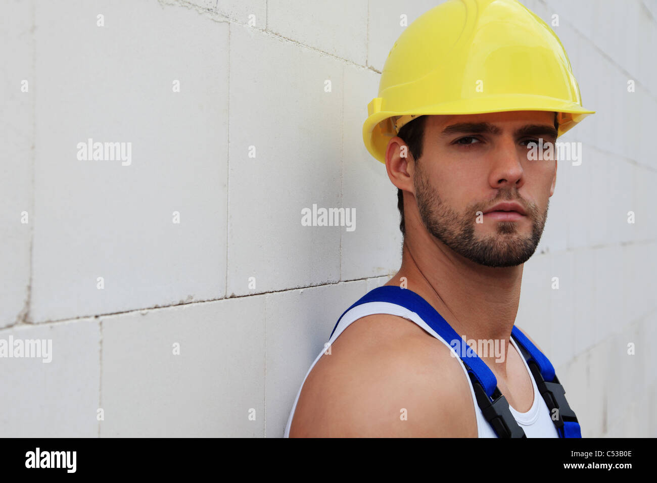 Manual worker on construction site Stock Photo - Alamy