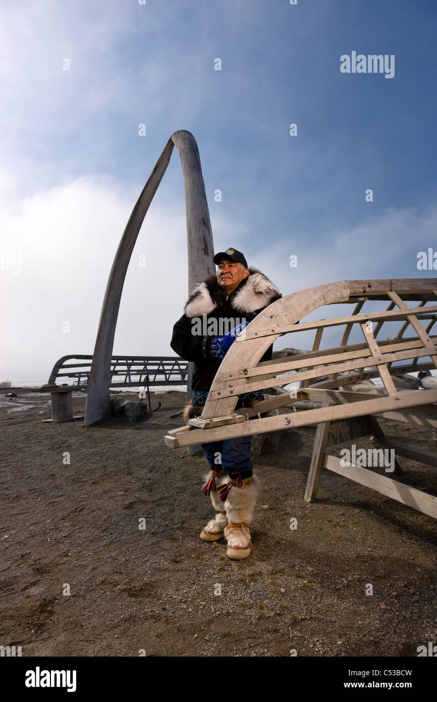 Male Inupiaq Eskimo hunter wearing his Eskimo parka , standing in front ...