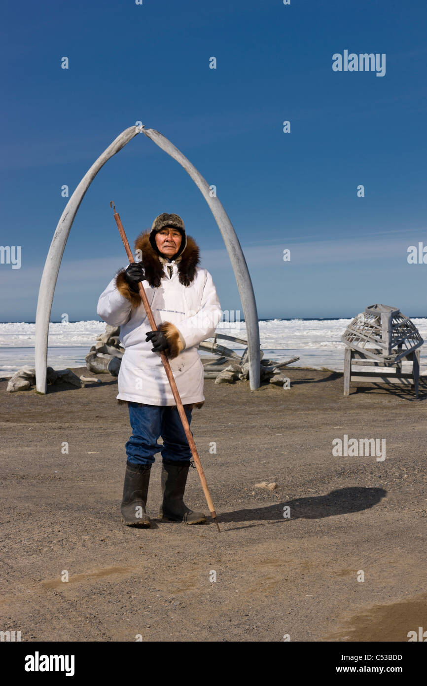 Male Inupiaq Eskimo hunter wearing his Eskimo parka , standing in front ...