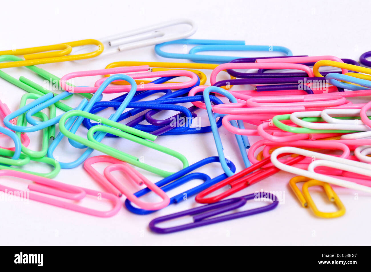 Colorful paper clips on a white background Stock Photo - Alamy