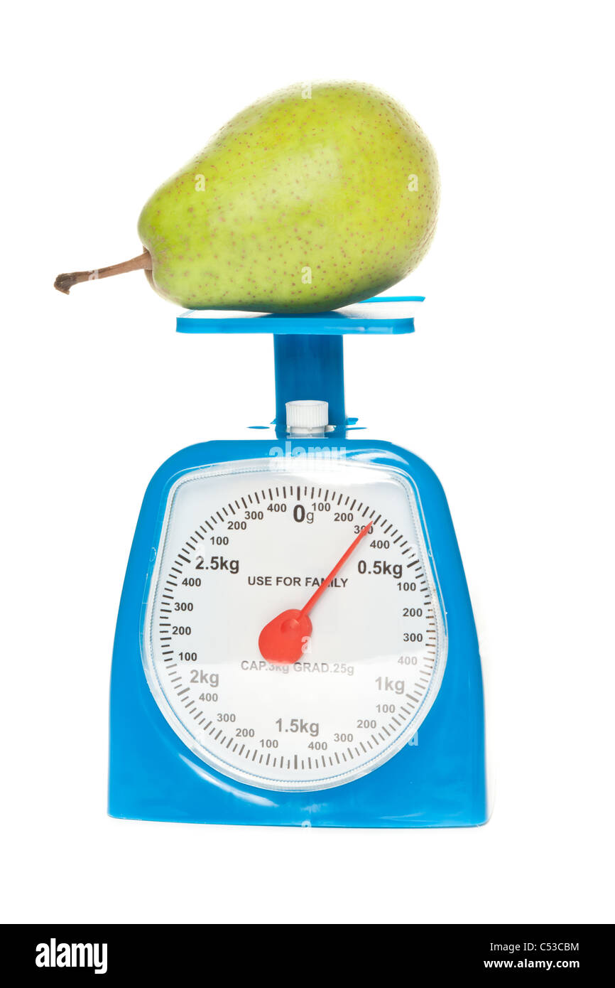 Woman's hands with scale and green pear isolated Stock Photo - Alamy