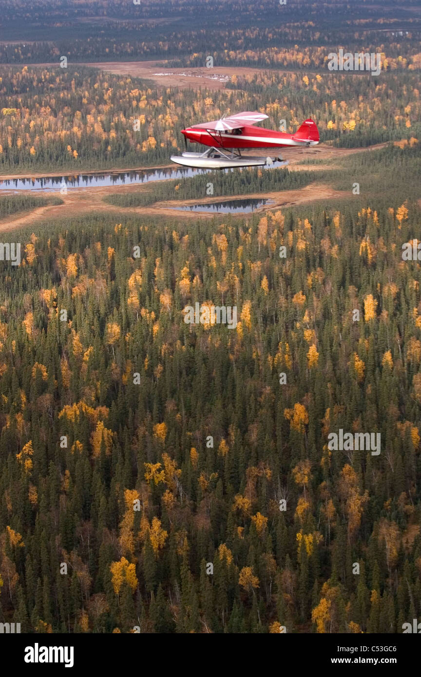 A red float plane flying over the Kenai National Wildlife Refuge ...