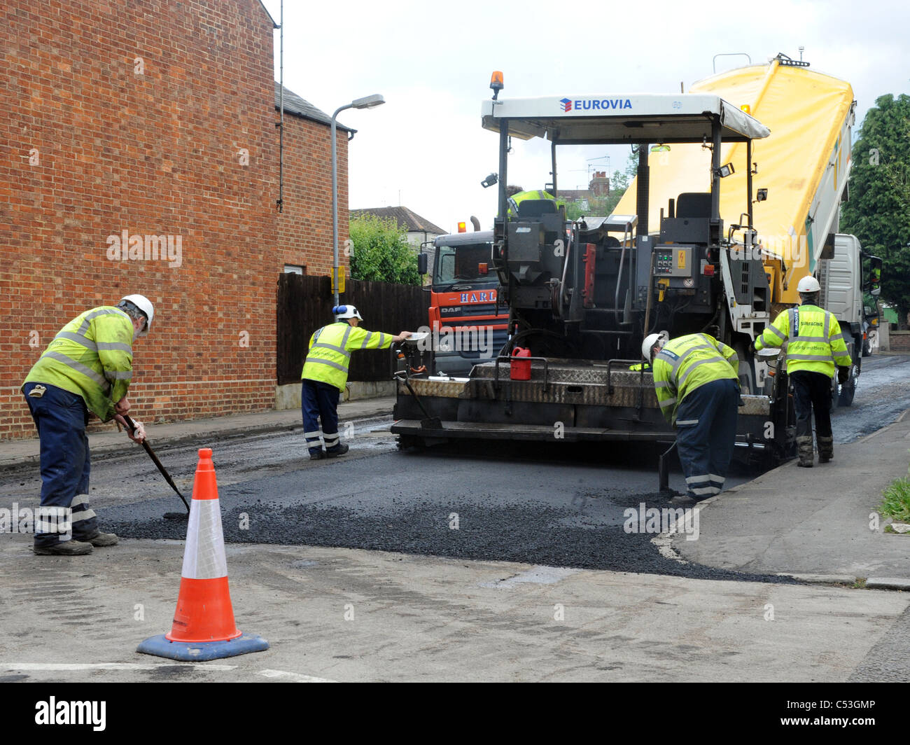 Local road resurfacing by council workers Stock Photo - Alamy