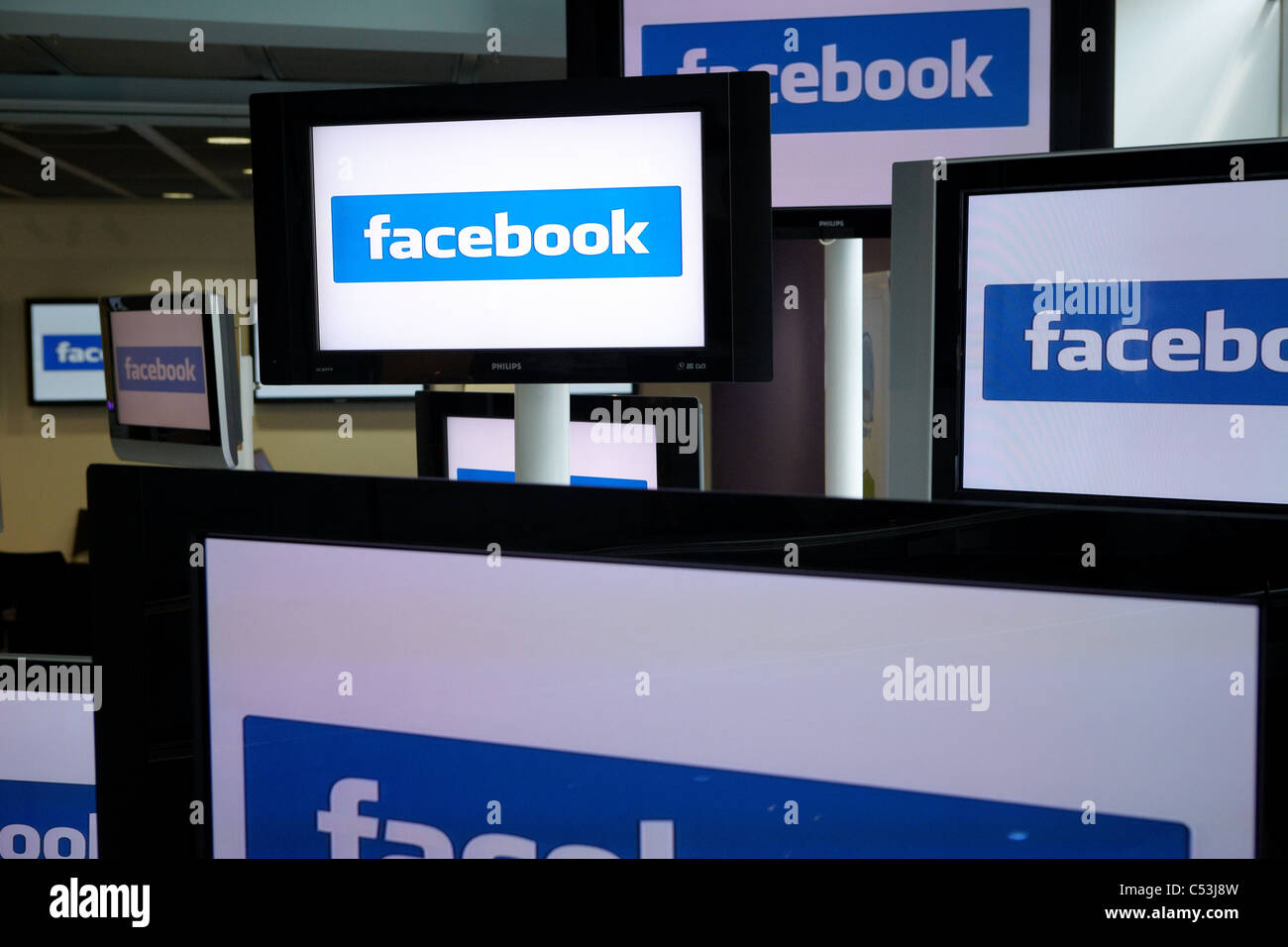 A bank of monitors showing the Facebook logo Stock Photo - Alamy