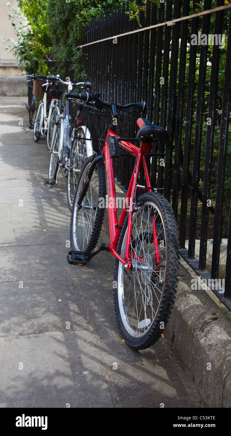 Bicycles padlocked to wrought iron railings Stock Photo - Alamy