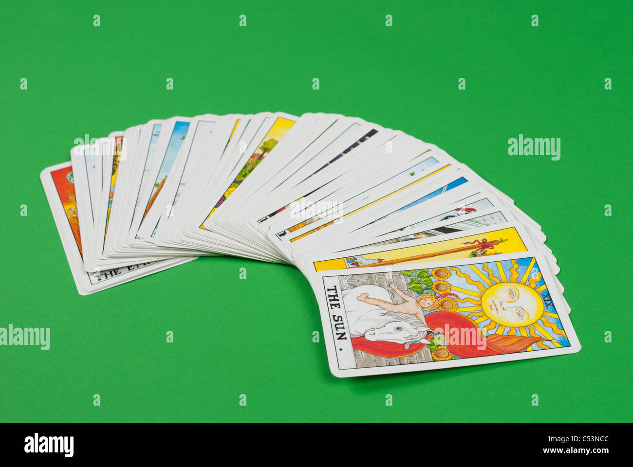 Deck of tarot cards fanned on a green table Stock Photo - Alamy