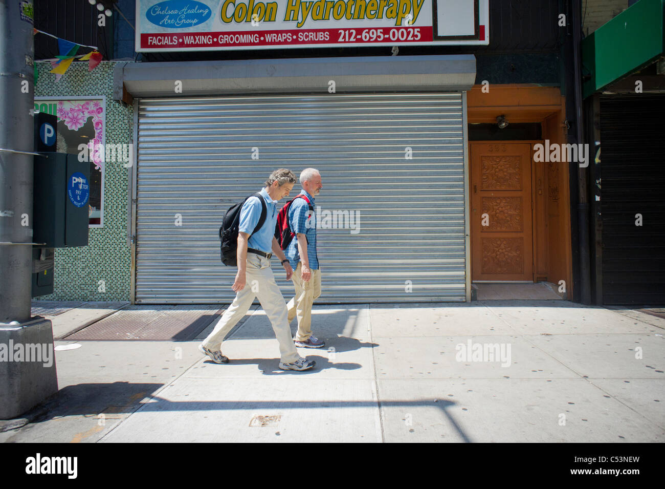 Security gates on a closed and shuttered storefront in the Chelsea ...