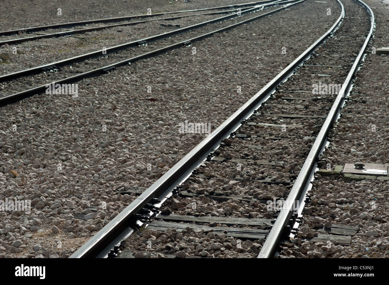 Several converging railway tracks in curve to the left Stock Photo - Alamy