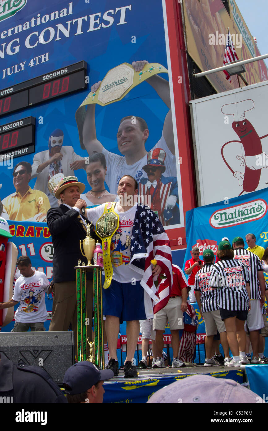 Joey Chestnut accepting the "Mustard Belt" and championship trophy at ...
