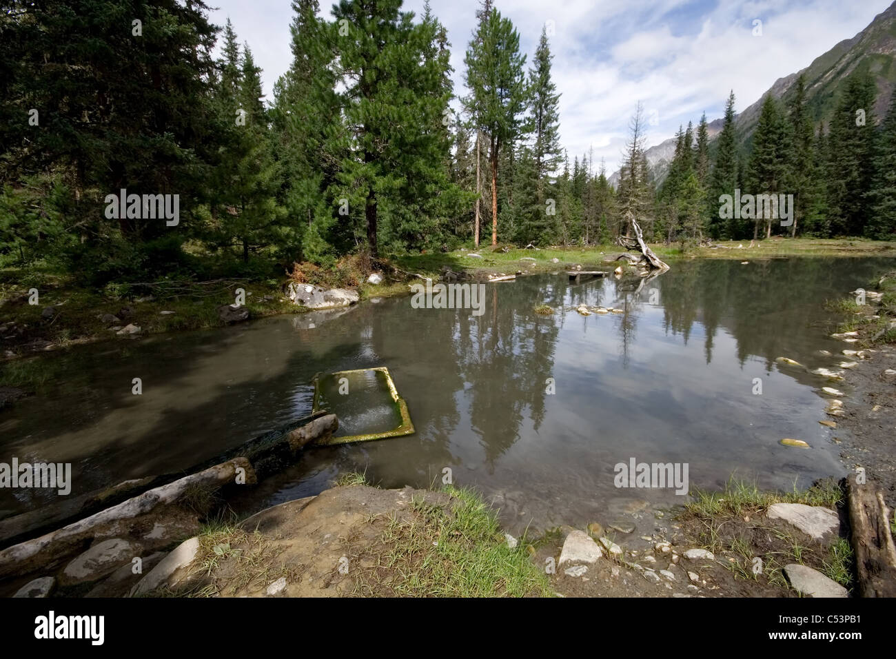 Mineral bath in Nature park Shumak. Shumak mineral springs. East Sayan ...