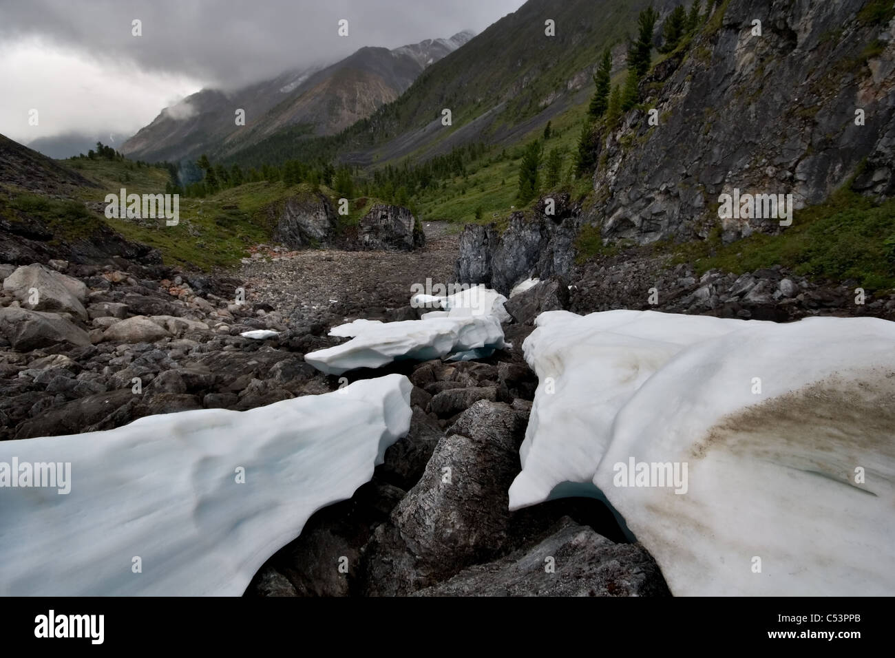 Valley with glacier ice blocks in Eastern Sayan mountains. Fog and ...