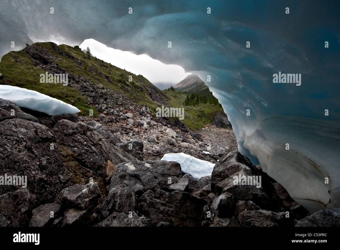 Fantastic blue wavy ice shape (glacier) against a valley in Sayan ...