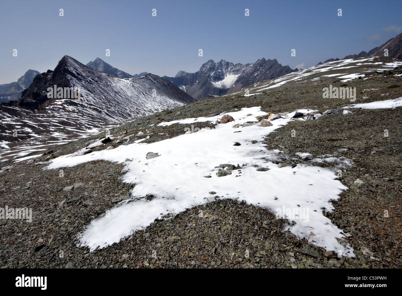 Rocks, snow, clouds and sky in Sayan mountains. Siberia. Russia Stock ...