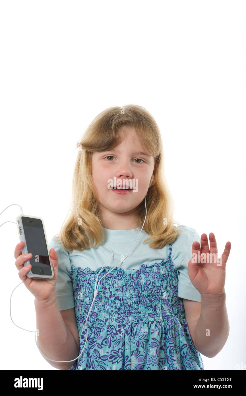 Young girl smiling and looking nicely surprised while holding a iphone ...