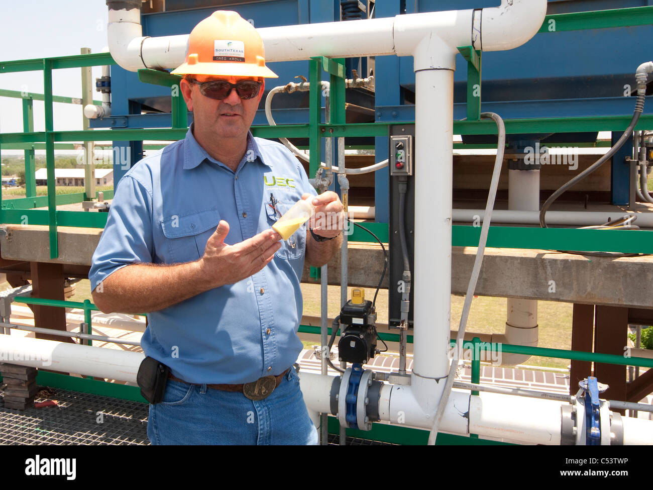 White male worker holds up a sample of processed Uranium at an Uranium ...