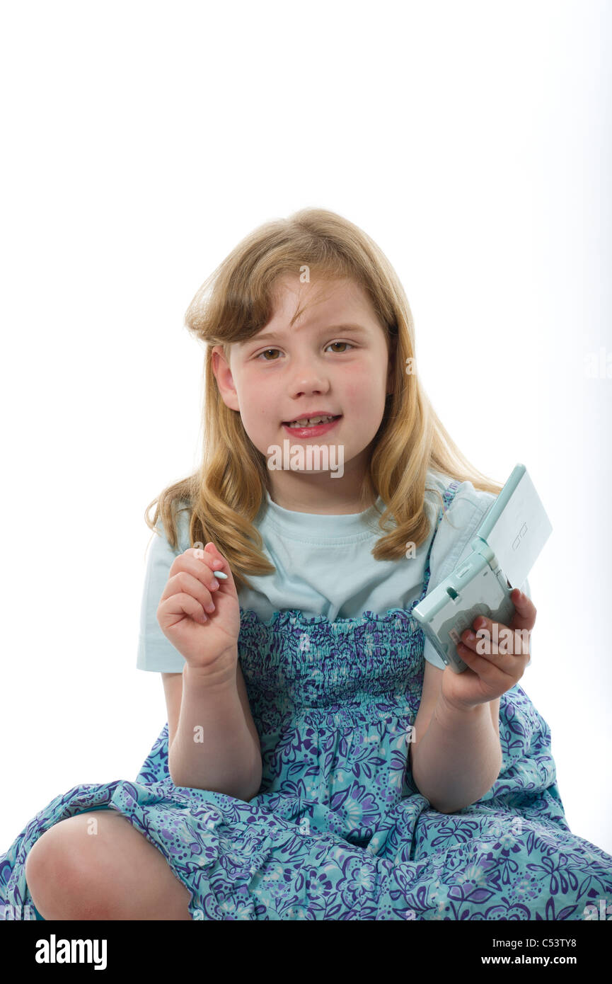 Young girl of primary age playing on a Nintendo DS game console, shot ...