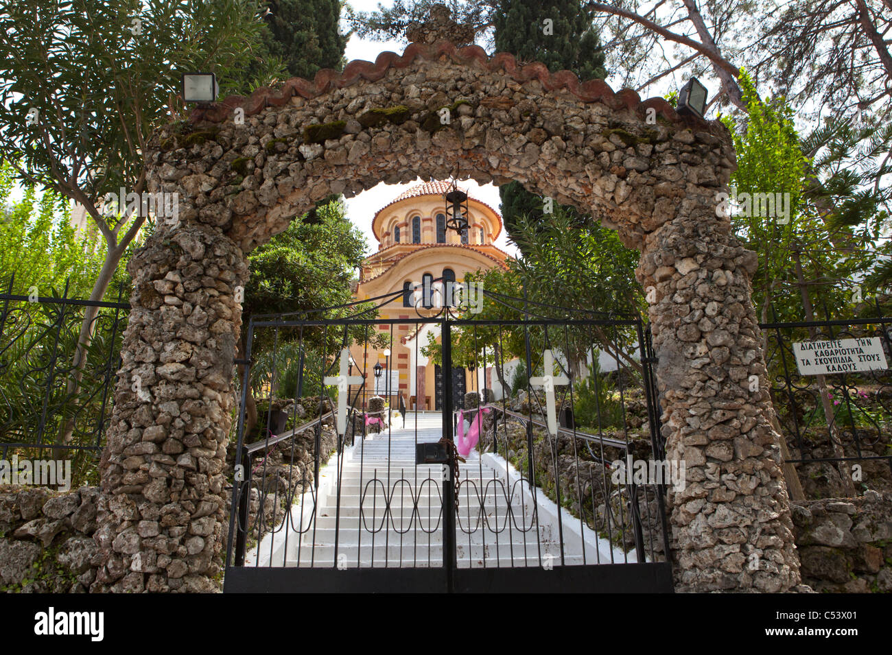 gate of saint nectarius monastery with the monastery in the backround ...