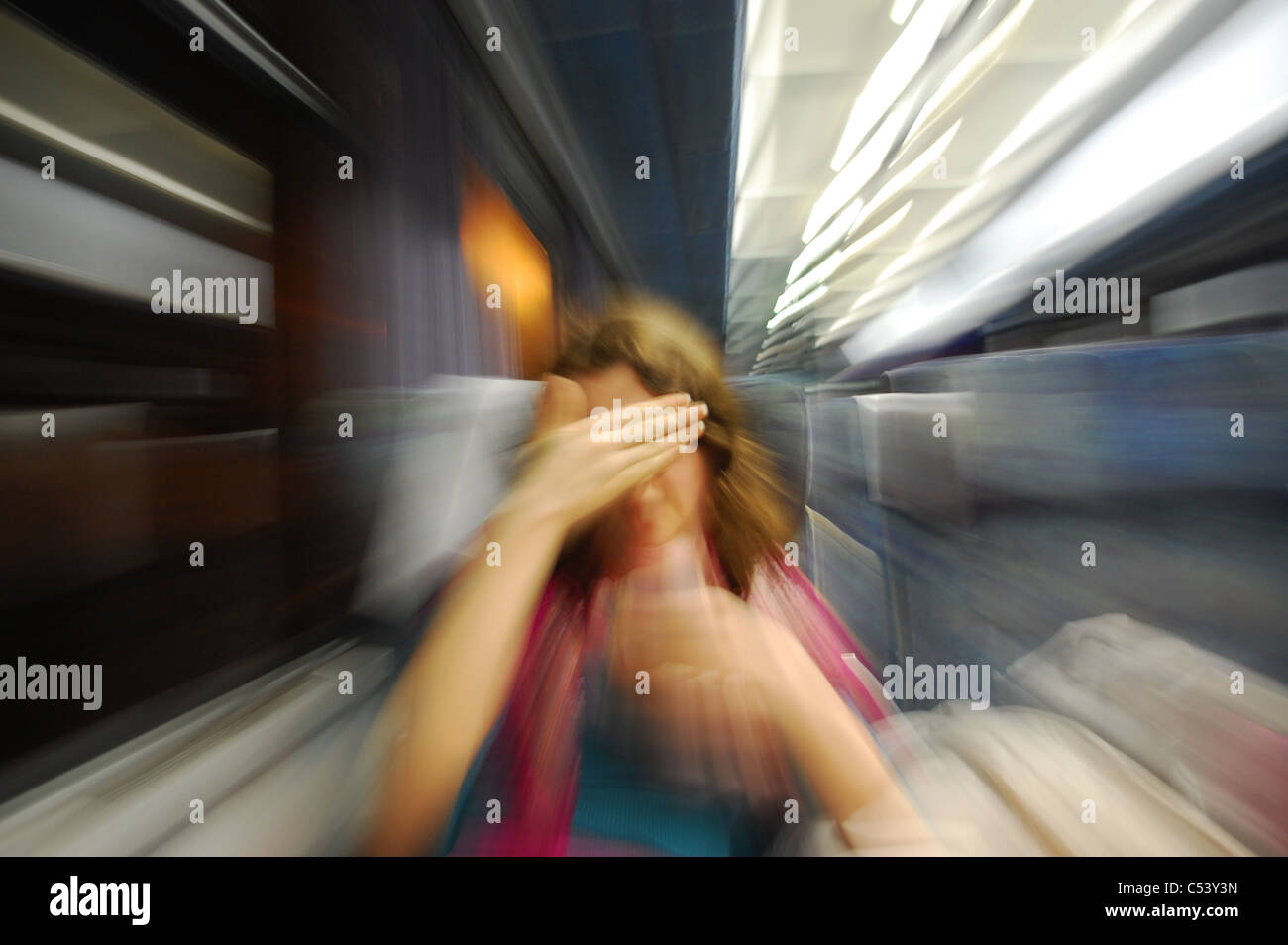 Zoom motion blur effect on girl hiding her face. Suggests shyness ...