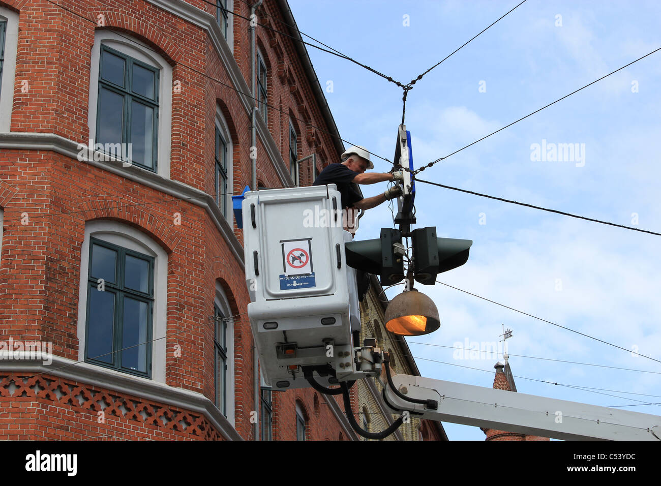 Handyman repairing traffic sign Stock Photo - Alamy
