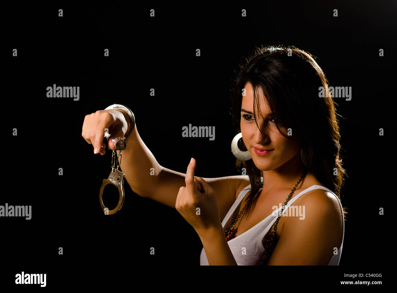 Girl with handcuffs, ready to hunt someone down Stock Photo - Alamy