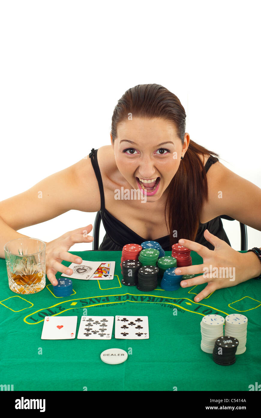 Excited woman won at casino and sitting at table isolated on white ...