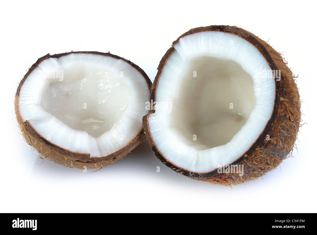 two halves of a coconut on white background Stock Photo - Alamy