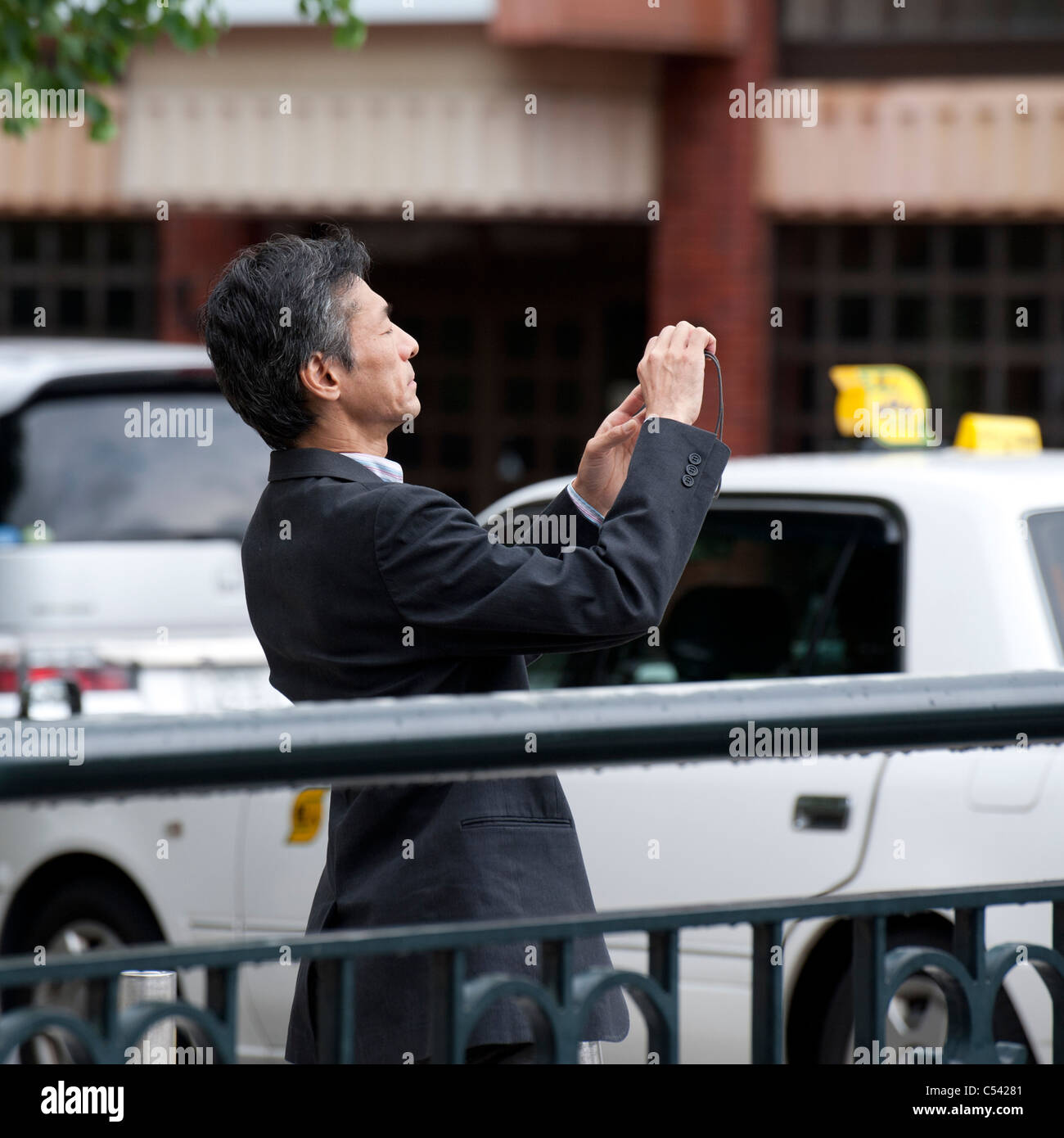 Man taking a picture with a camera, Nagasaki, Japan Stock Photo - Alamy