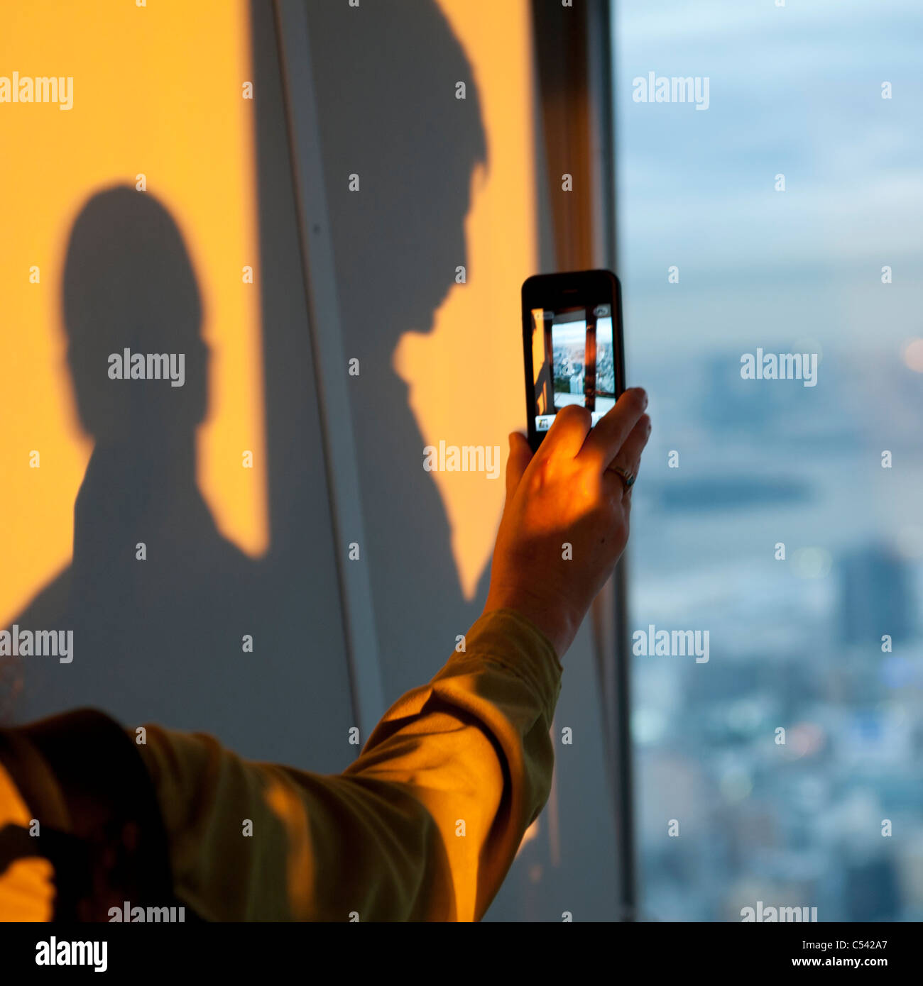 Person taking a picture with a mobile phone, Tokyo Tower, Minato Ward ...