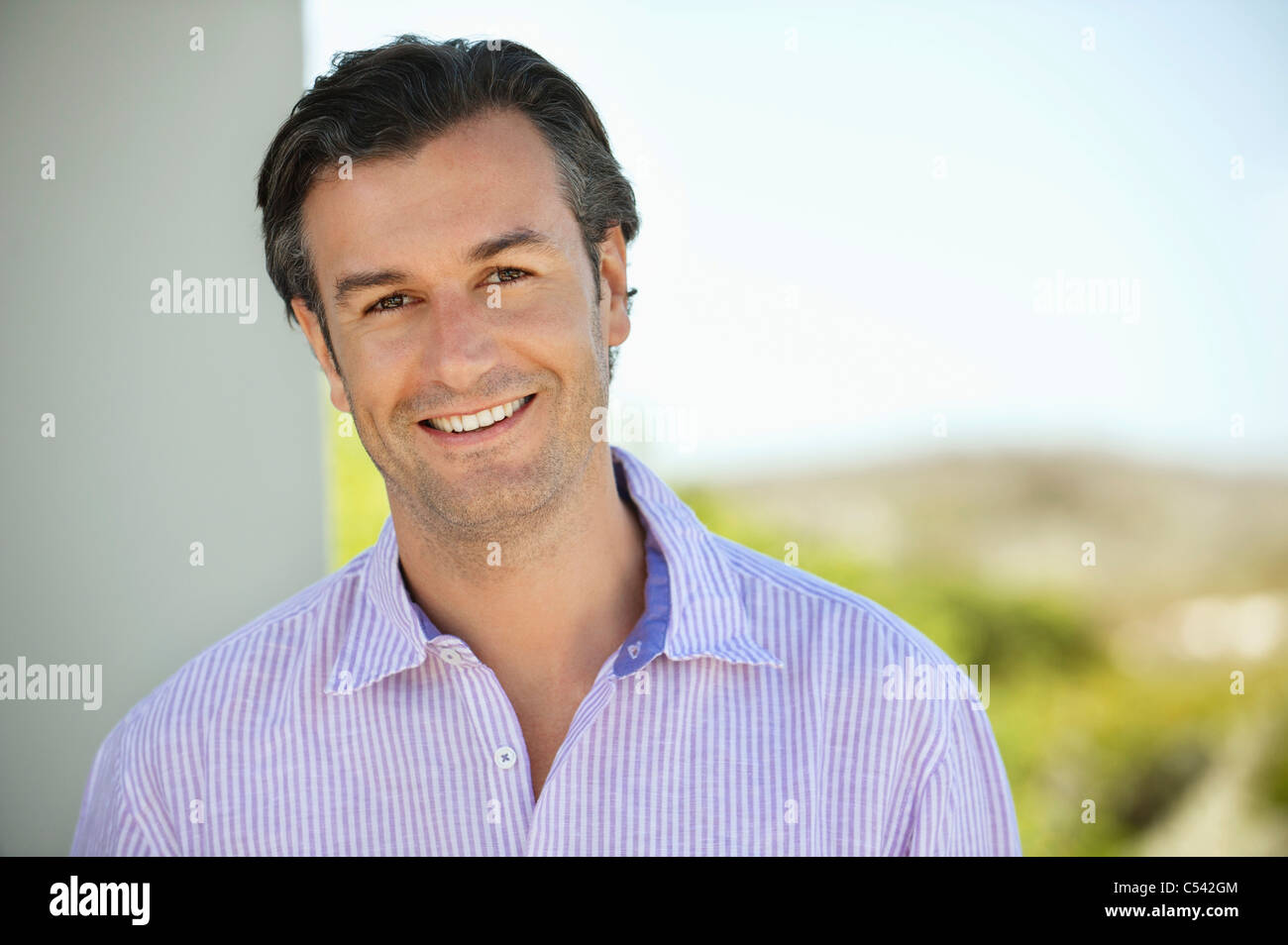 Smiling mid adult man in hi-res stock photography and images - Alamy