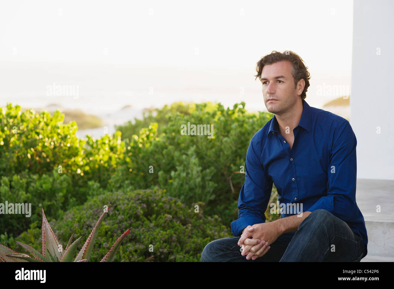 Mid adult man thinking Stock Photo - Alamy