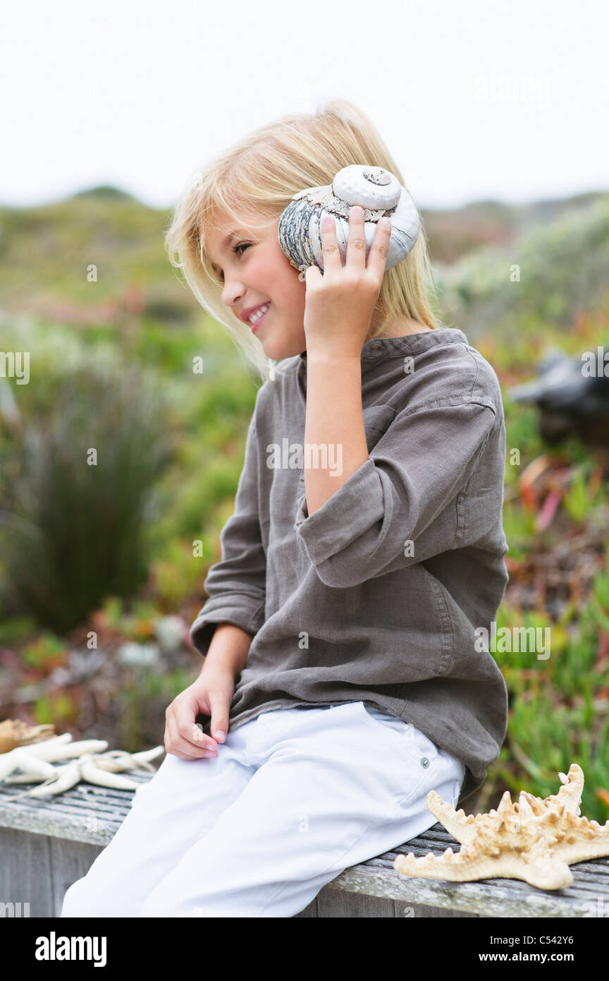 Conch shell listening hi-res stock photography and images - Alamy