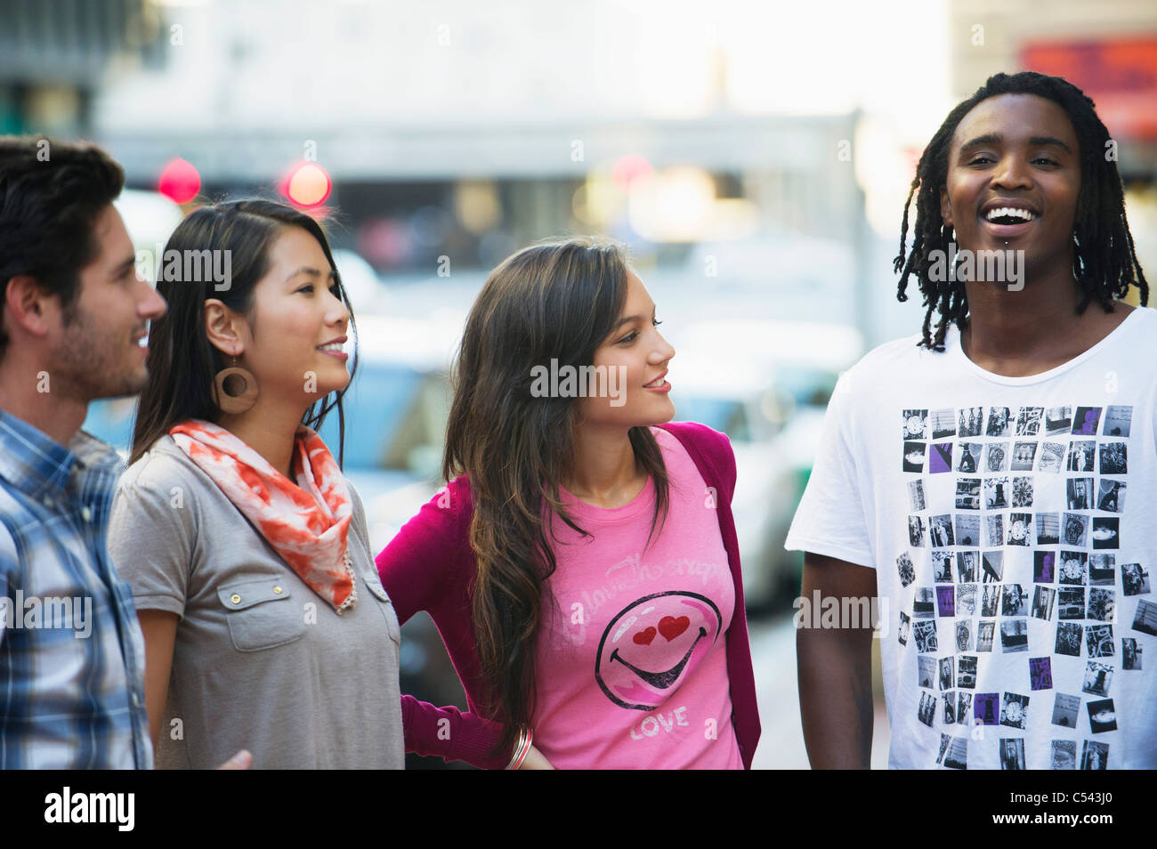 Friends standing together and smiling Stock Photo - Alamy