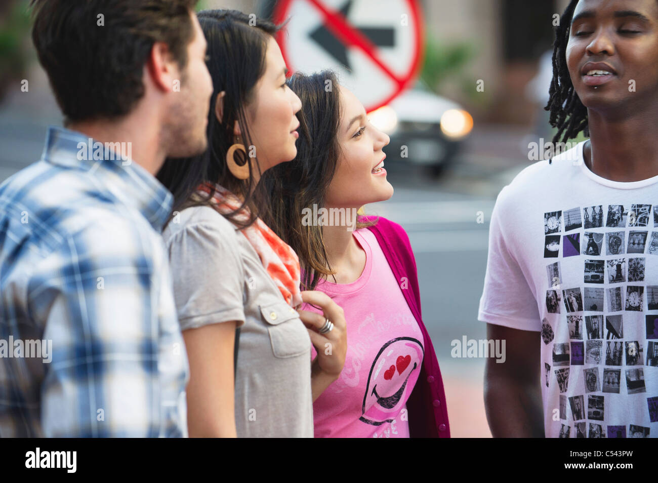 Friends standing together and smiling Stock Photo - Alamy