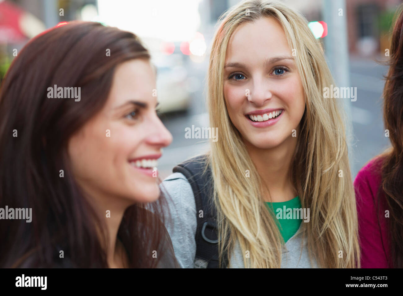 Portrait of a beautiful woman with friends outdoors Stock Photo - Alamy