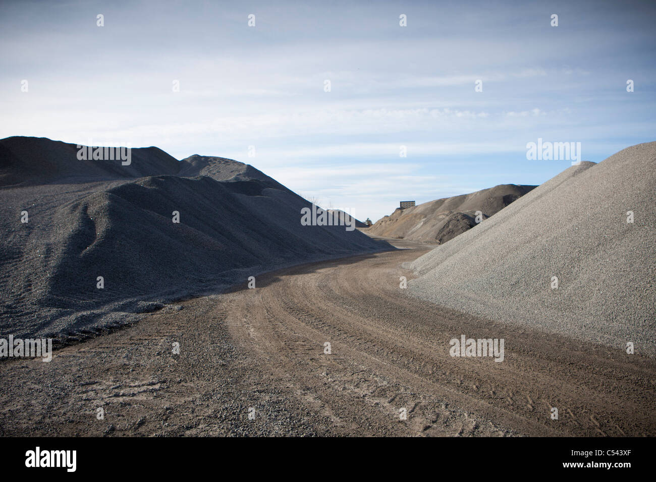 Hills of artificial ground with a path made from quarry machine and ...