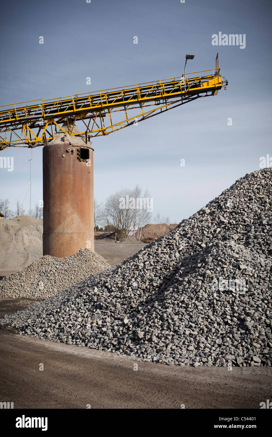 Quarry machines in a landscape of artificial hills of ground and rocks ...