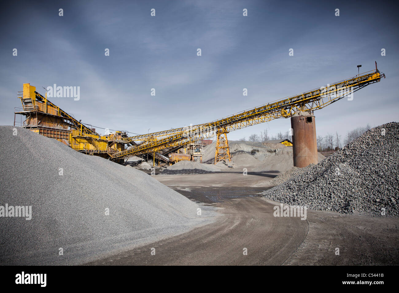 Quarry machines in a landscape of artificial hills of ground and rocks ...